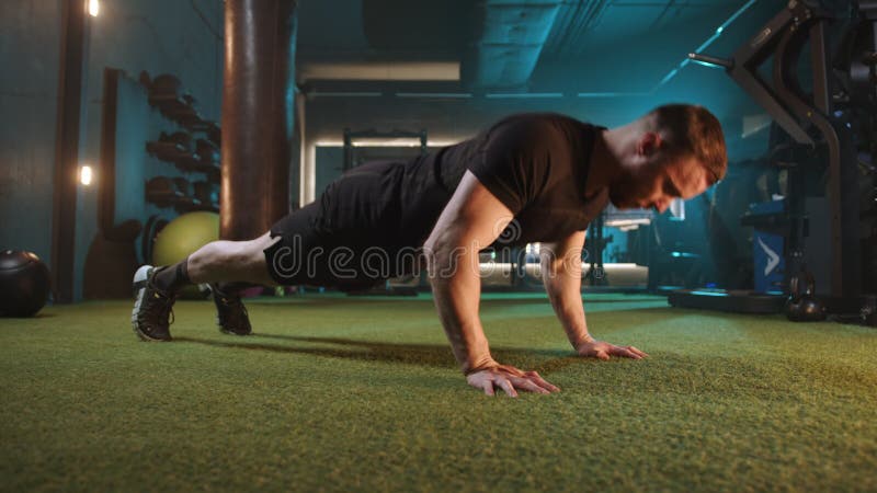 Focused Man in a Gym Doing Floor Push-ups for Strength Training Session ...