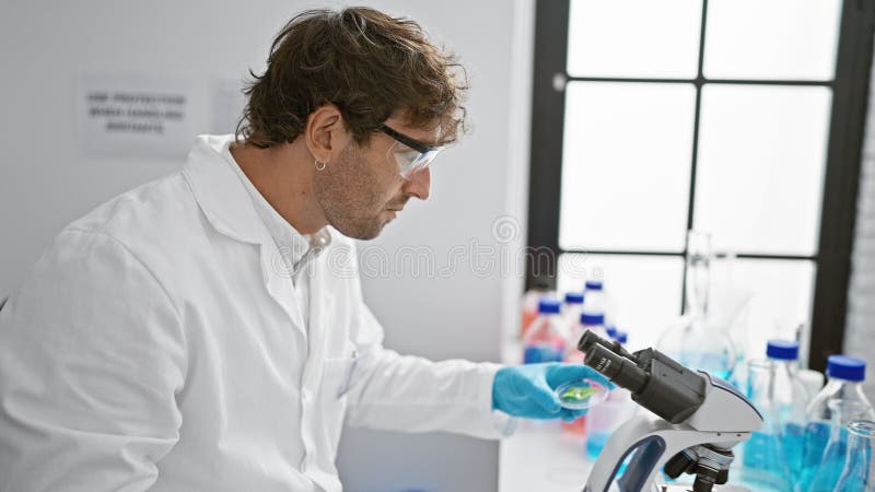Man in a Lab Coat Using a Microscope To Examine a Sample, Suitable for ...