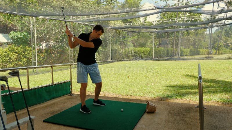 Focused Man Practicing Golf Swing on Stock Image - Image of play ...