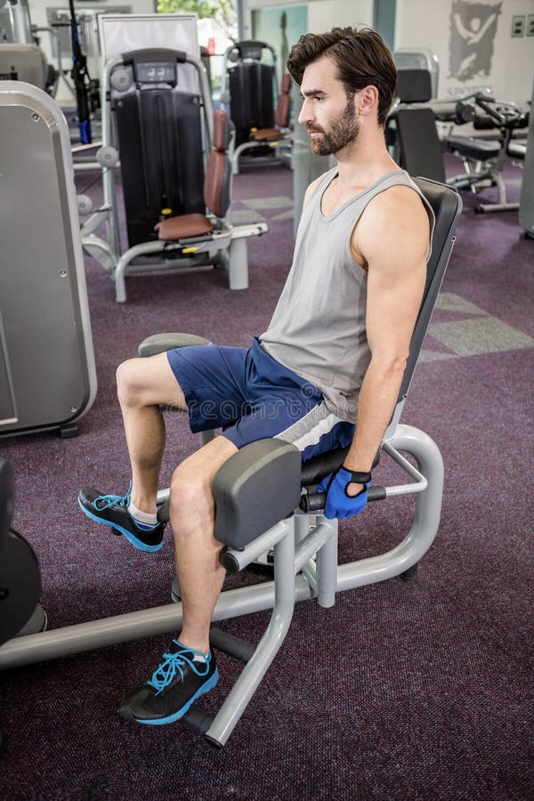 Focused Man Using Weights Machine for Legs Stock Image - Image of ...