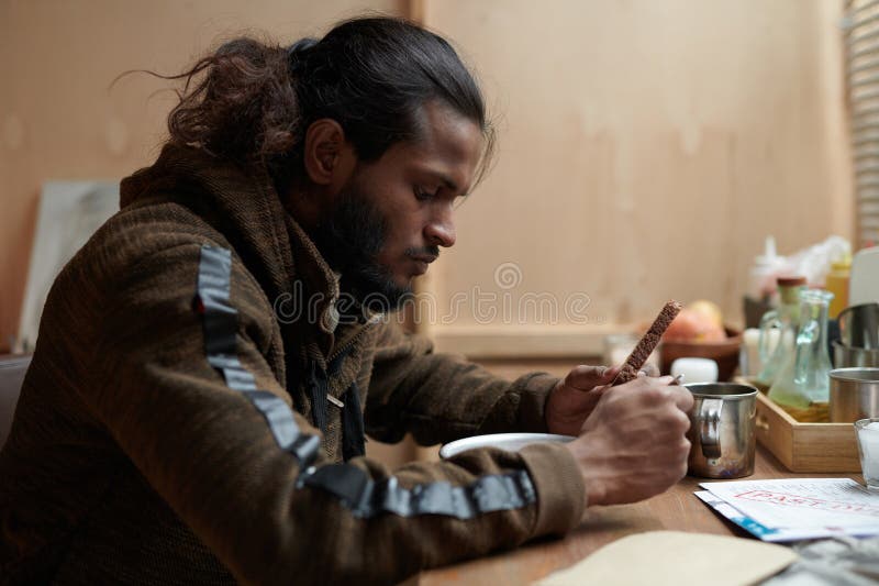 Focused Man Working on Project in Cozy Workspace Setting Stock Photo ...