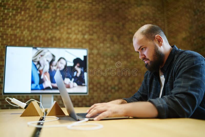 Focused Man Working Remotely on Computer in Workspace Stock Photo ...