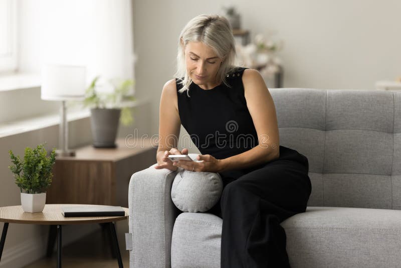Focused Mature Woman Using Online Application, Internet Service Stock ...