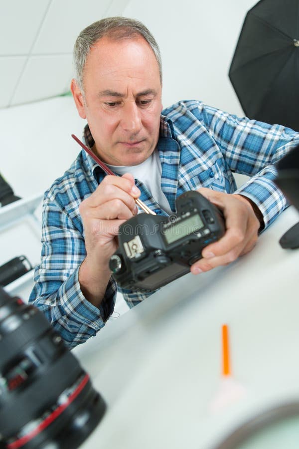 Focused Middle-age Man Fixing Retro Camera at Workplace Stock Photo ...