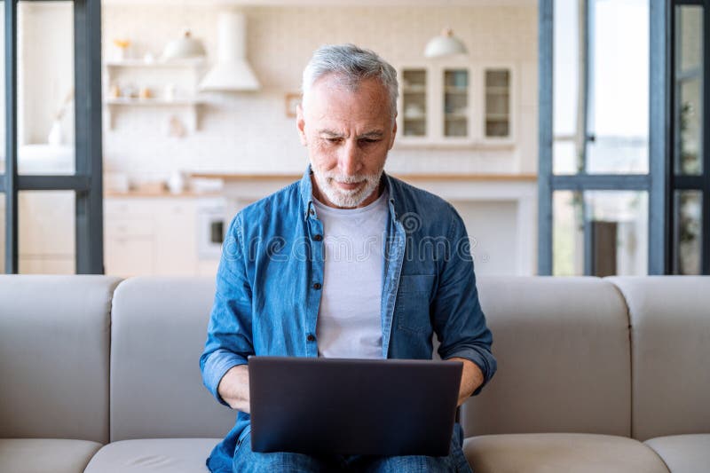 Focused Middle Aged Man Working Remote and Reading Emails on Laptop ...