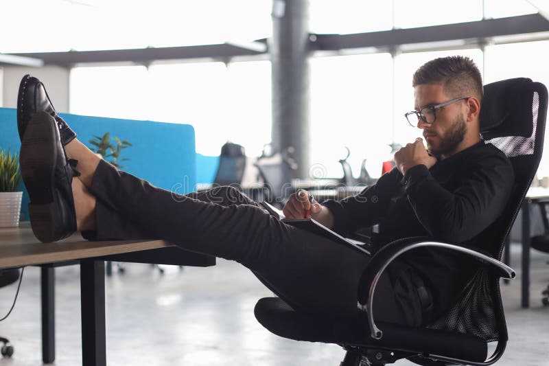 Focused Modern Businessman Working and Taking Notes in His Modern ...