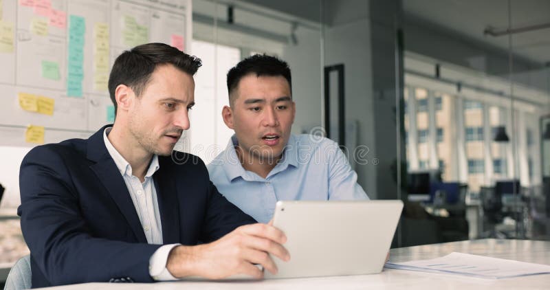 Focused Multiethnic Business Colleagues Using Tablet for Teamwork Stock ...