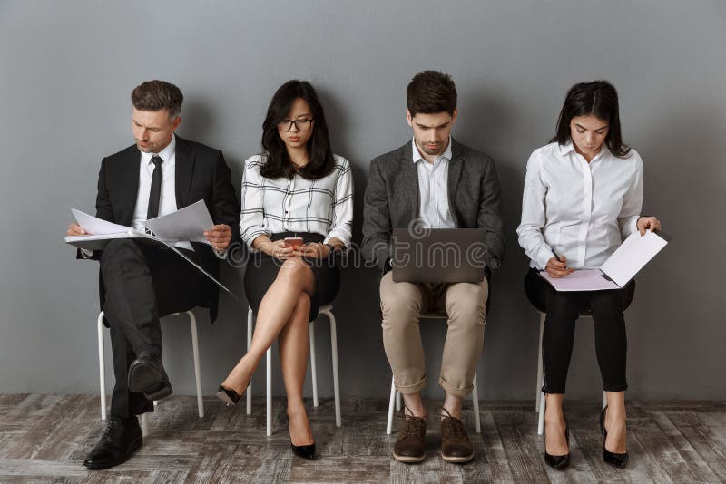 Focused Multiethnic Business People with Digital Devices and Folders ...