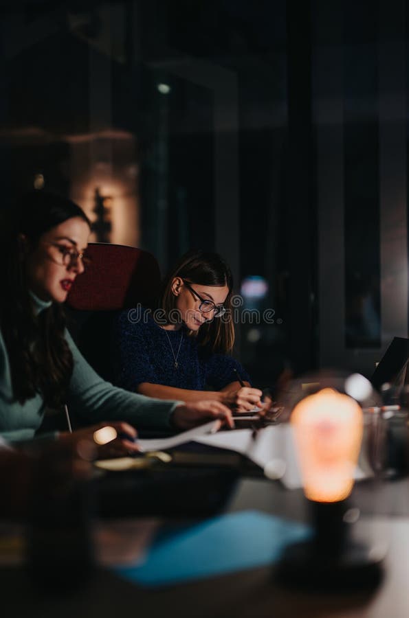 Focused Multigenerational Team Engaged in a Collaborative Effort at a ...