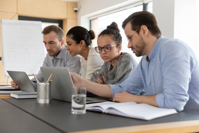 Multiethnic Employees Wok in Groups on Laptops Stock Photo - Image of ...