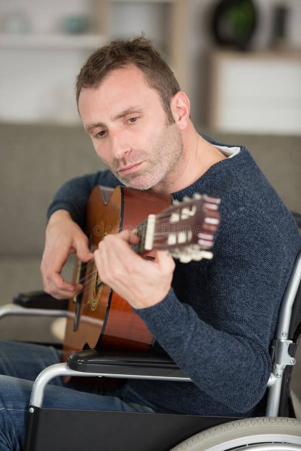 Focused Musician in Wheelchair Playing Guitar Stock Image - Image of ...