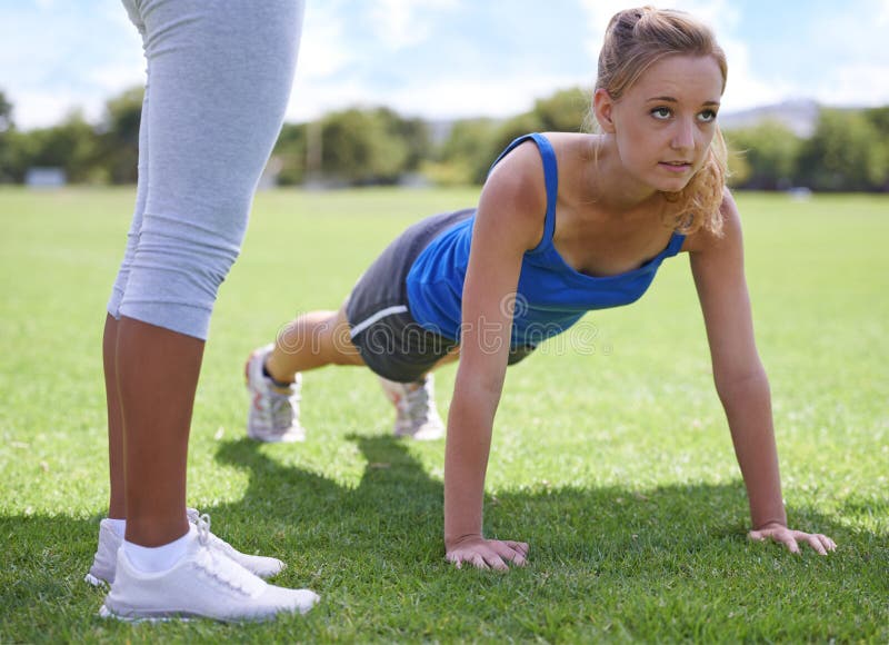 Focused on the Next Pushup. a Woman Doing Push Ups at an Outdoors ...