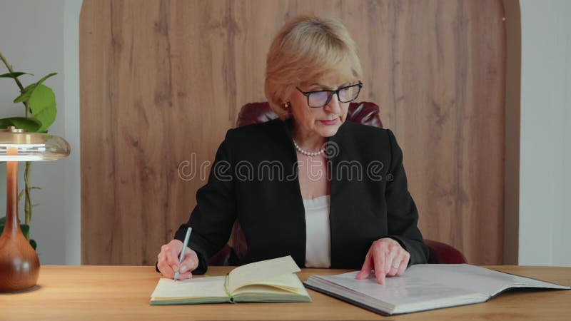 Focused Older Woman Making Notes during Document Review Stock Video ...