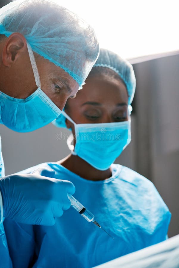 Focused on the Operation. Two Surgeons Operating on a Patient in a ...