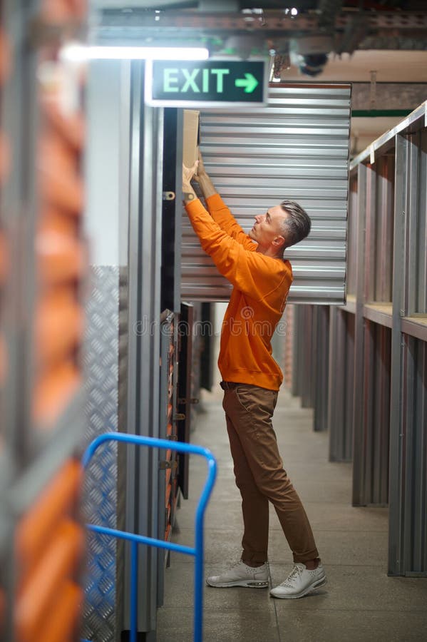 Focused Order Picker Picking Ordered Goods for Shipping Stock Photo ...