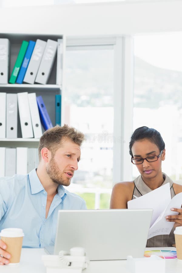 Focused Partners Analyzing Business Plan on Laptop during Office ...