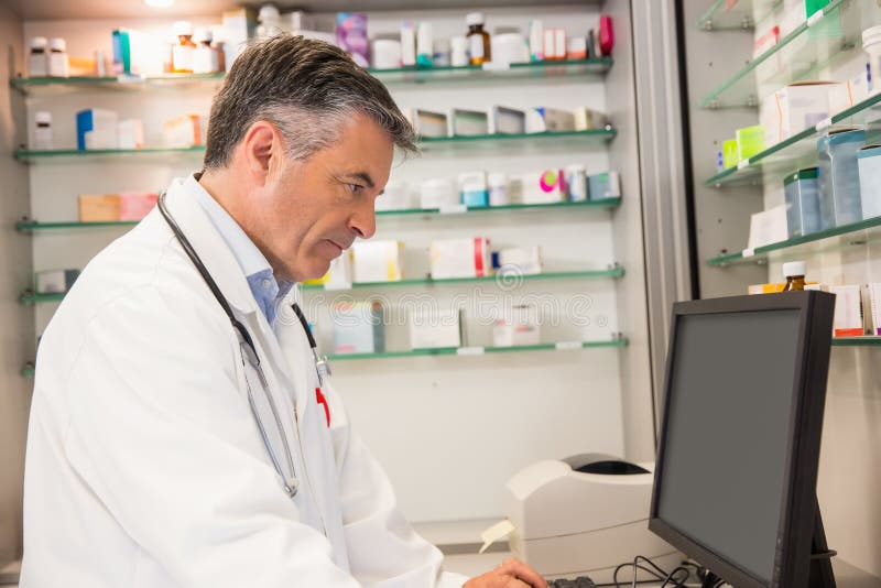 Focused Pharmacist Using the Computer Stock Photo - Image of indoors ...