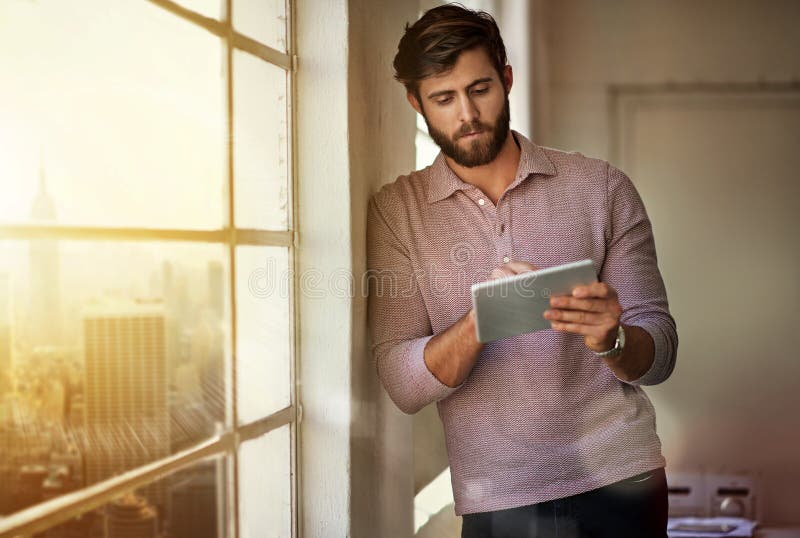 Focused on the Plan at Hand. a Businessman Using a Digital Tablet in ...