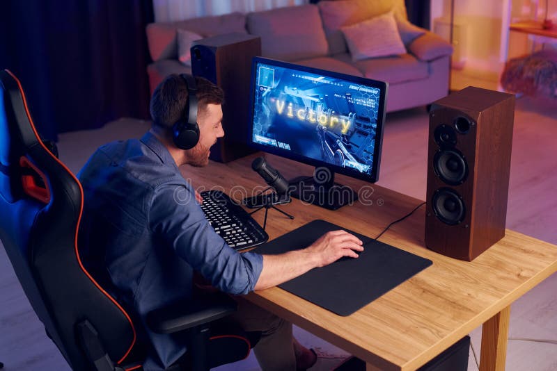 Focused on the Playing. Man Streaming FPS Shooter Game at Home Stock ...