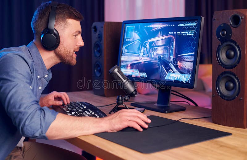 Focused on the Playing. Man Streaming FPS Shooter Game at Home Stock ...