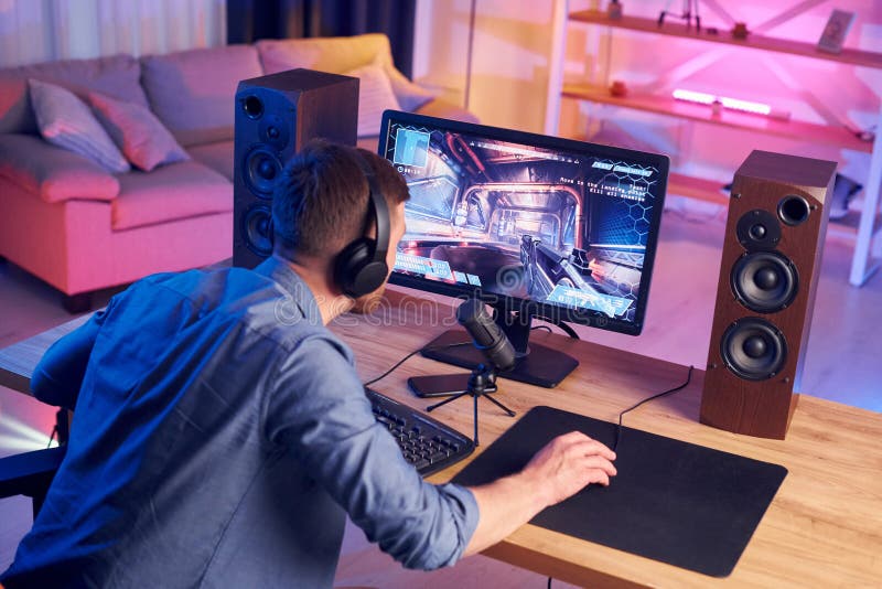 Focused on the Playing. Man Streaming FPS Shooter Game at Home Stock ...