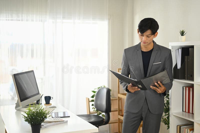 Focused Professional Businessman Reviewing Documents at His Desk Stock ...