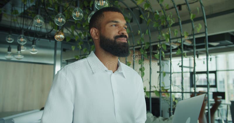 A Focused Professional Engaged in a Modern Workspace while Using a ...