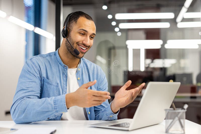 Professional Man Using Laptop and Headphones in Office Stock Image ...