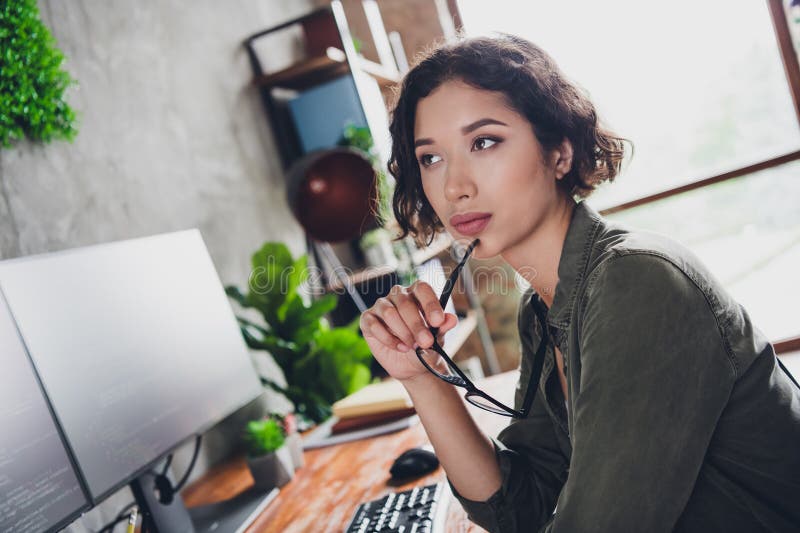 Young Woman in a Casual Setting Working with a Computer, Demonstrating ...