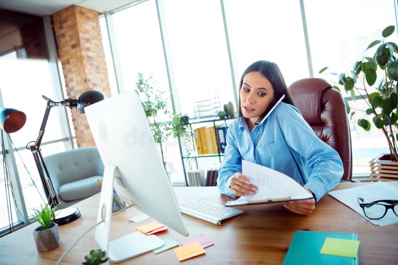 Focused Professional Woman Managing Tasks in a Vibrant Office Setting ...
