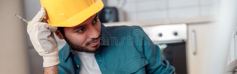 Focused Professional Worker in Uniform is Assembling Furniture on ...
