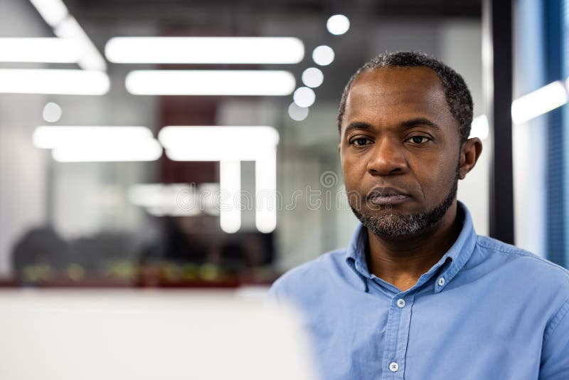 Focused Professional Working on Laptop in Modern Office Environment ...