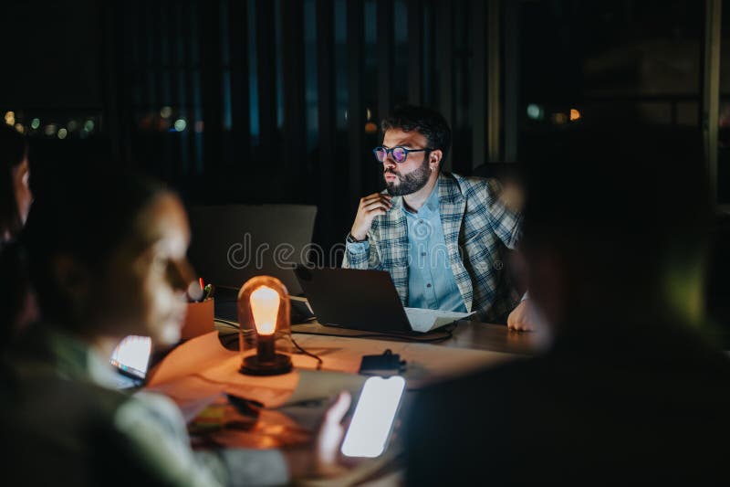 Business Coworkers Collaborating during a Late Night Office Meeting ...