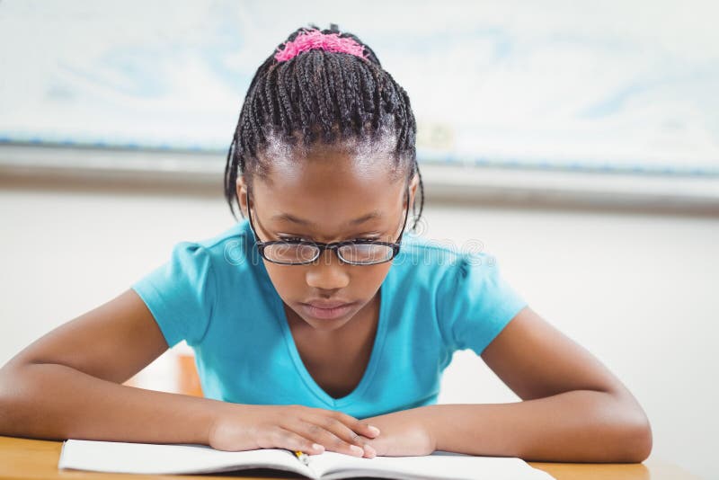 Focused Pupil Reading Book in a Classroom Stock Photo - Image of ...