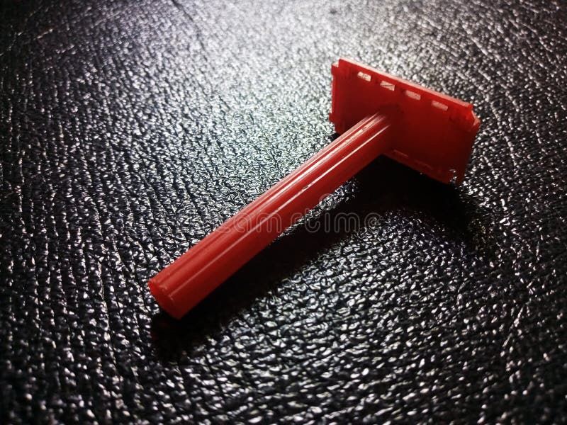 Focused Red Razor on Black Wrinkled Surface Stock Image - Image of ...