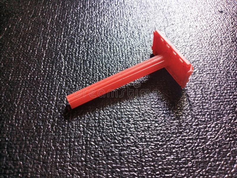Focused Red Razor on Black Wrinkled Surface Stock Photo - Image of ...