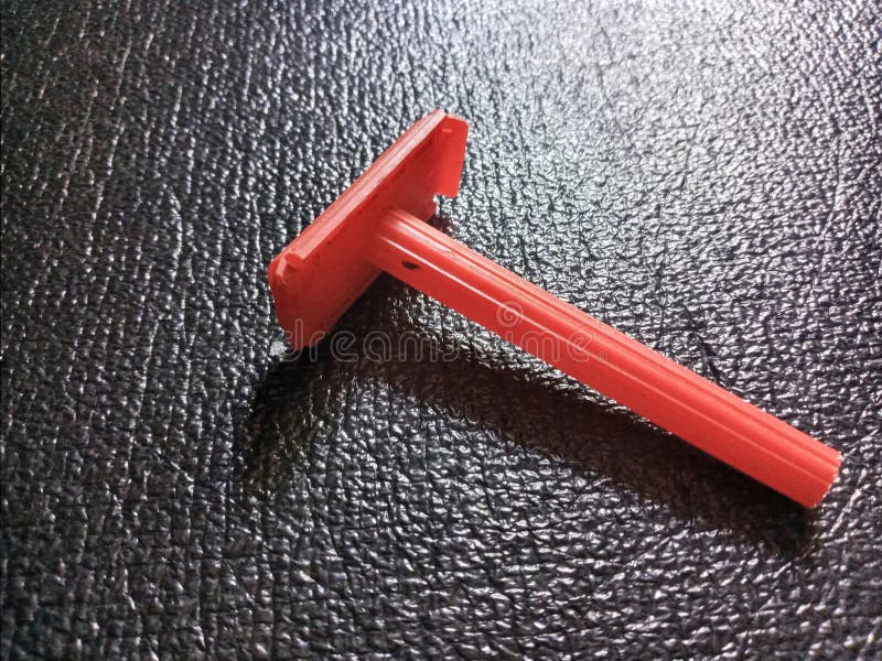Focused Red Razor on Black Wrinkled Surface Stock Photo - Image of ...