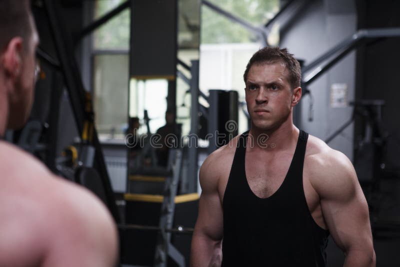 Bodybuilder Looking in the Mirror at the Gym Stock Image - Image of ...