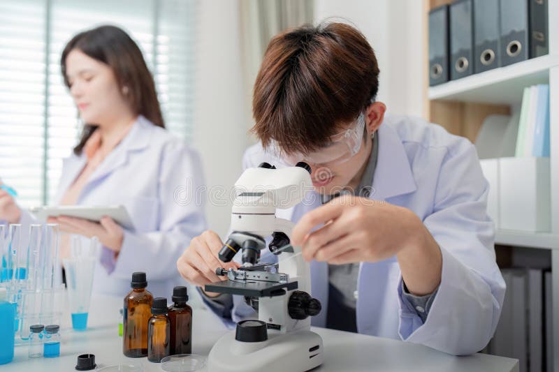 Focused Scientist Using Microscope for Chemical Observations Stock ...