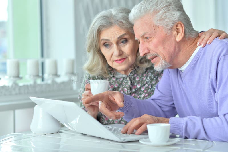 Focused Senior Couple Using Laptop Stock Image - Image of couple ...