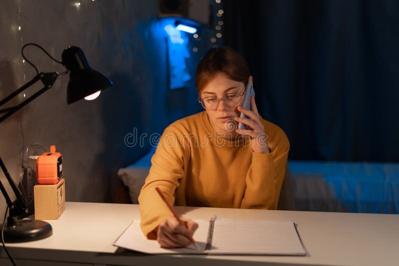 Focused Student in Dormitory Room Sitting at Table with Notebook and ...