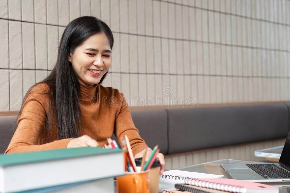 Study Session and Collaboration. a Woman Smiles while Organizing Her ...
