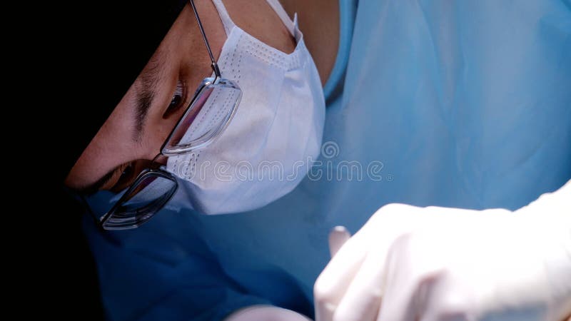 Focused Surgeon Performs a Precise Operation in a Sterile Operating ...