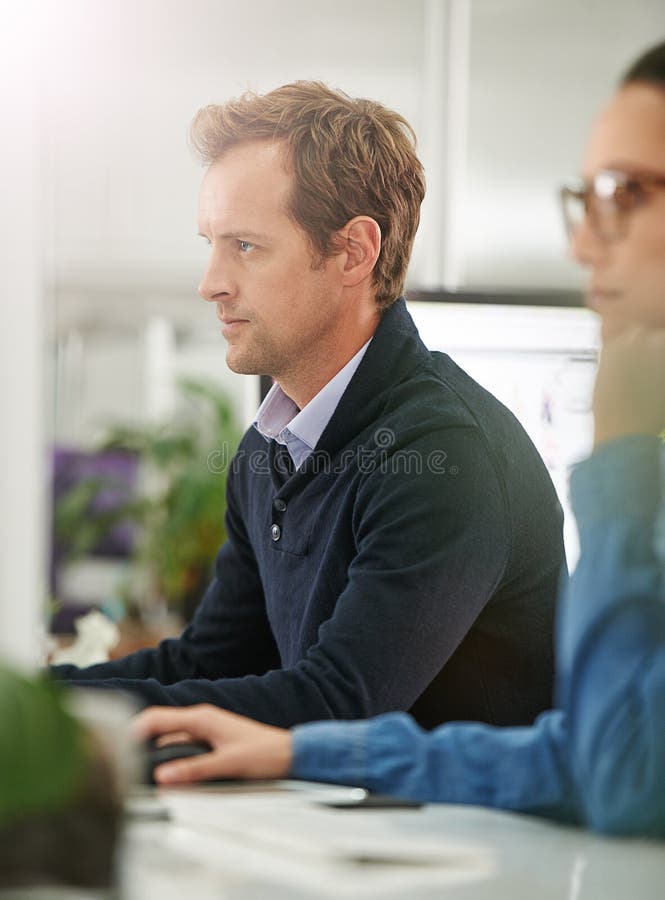 Focused on the Task at Hand. Two Colleagues at Their Desks. Stock Photo ...