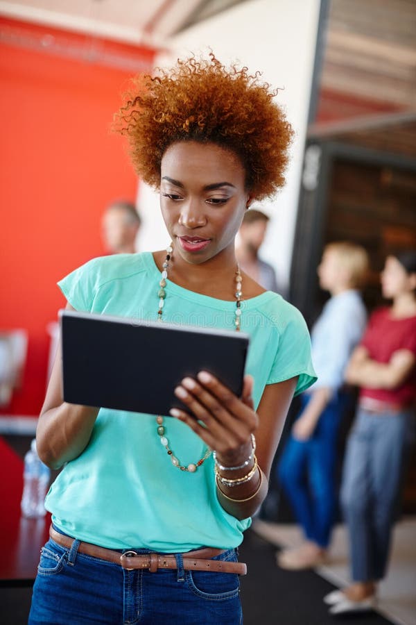 Focused on the Task at Hand. a Young Designer Using a Tablet with Her ...