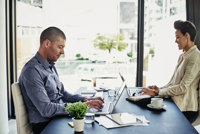 Focused on the Tasks at Hand. Two Colleagues Working in Their Office ...