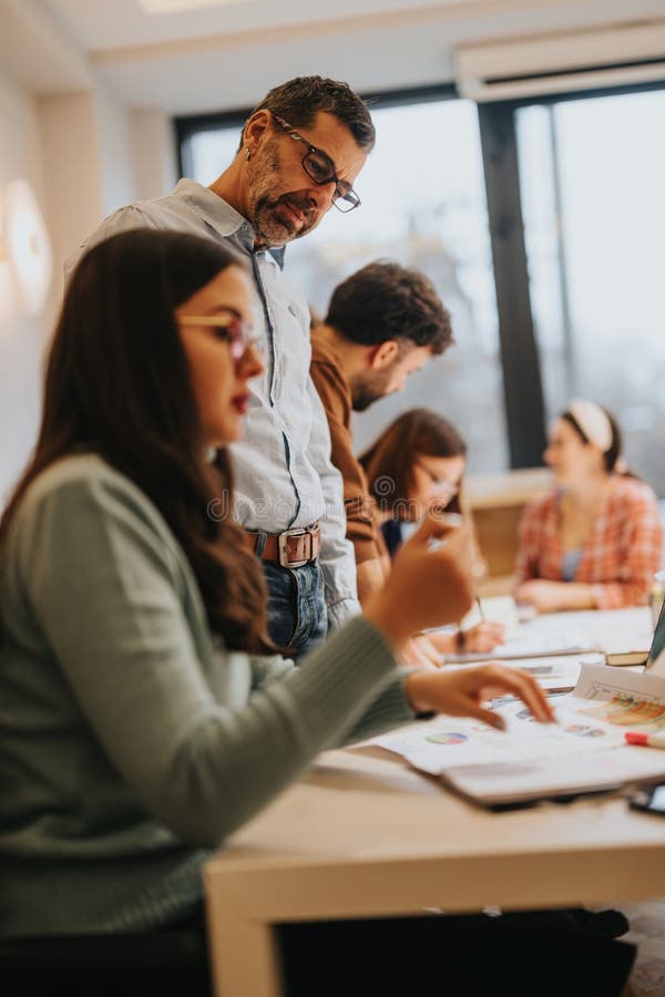 Focused Team Engaged in Project Discussion at Creative Office Workspace ...