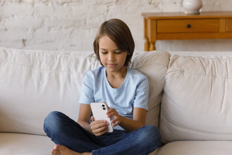 Focused Teen Kid Browsing Internet on Mobile Phone at Home Stock Photo ...