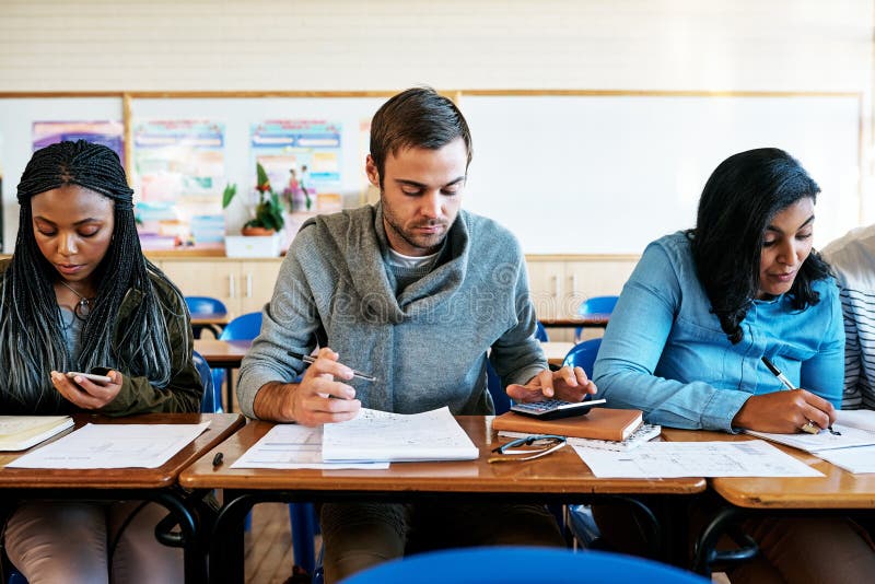 Focused on Their Studies. a Group of Young University Students Working ...