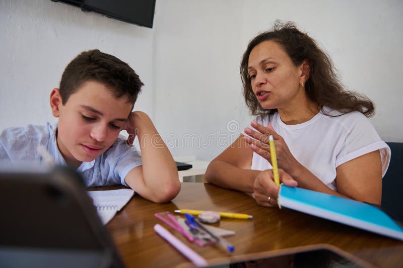 Focused Tutoring Session between Student and Teacher in Casual Setting ...